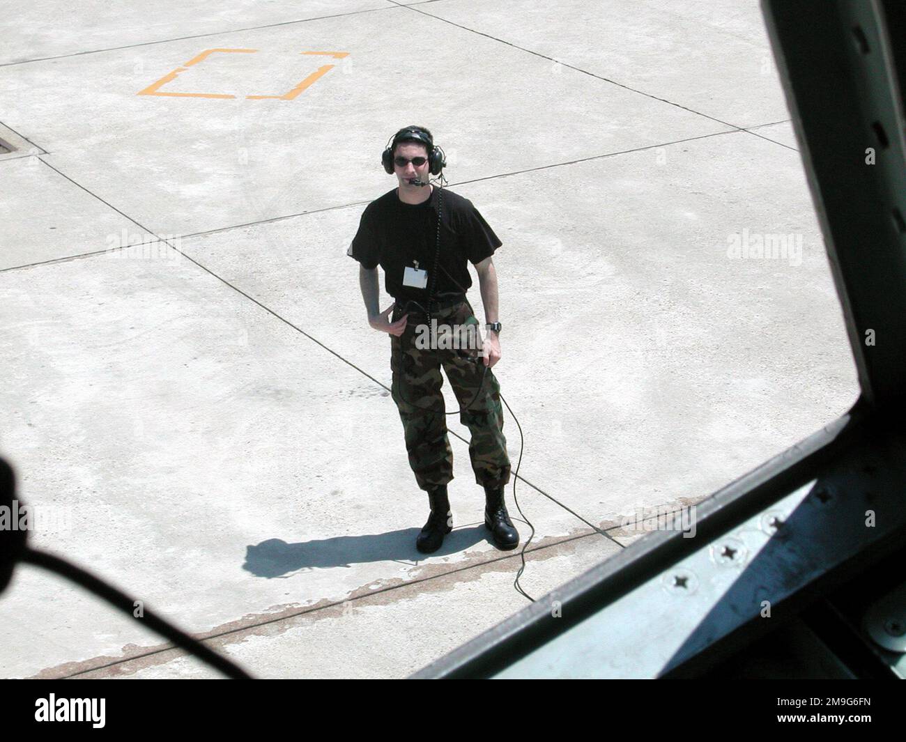 STAFF Sergeant (SSGT) Brian Patni, USAF, communicates via comm cord ...