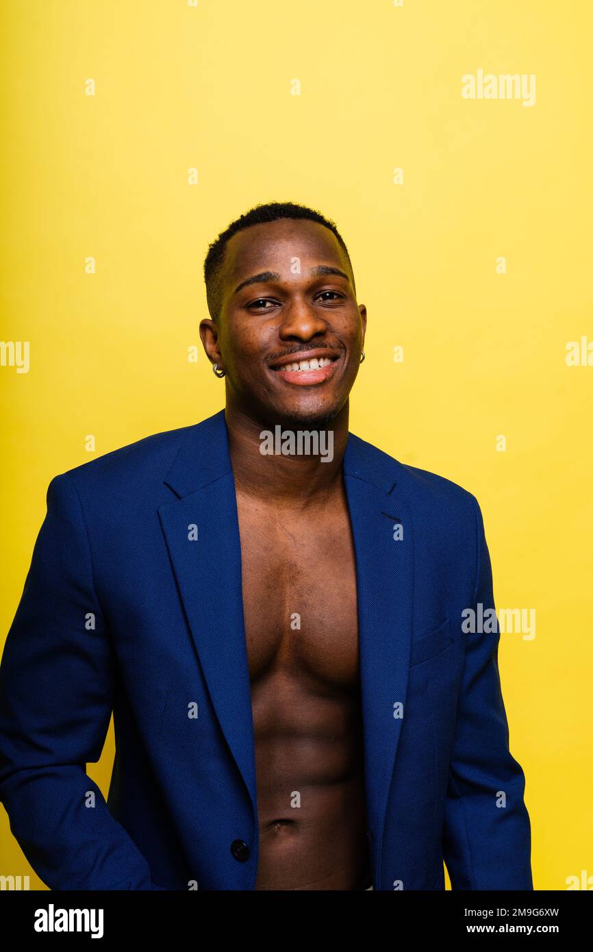 Smiling young african american man guy isolated on yellow background ...