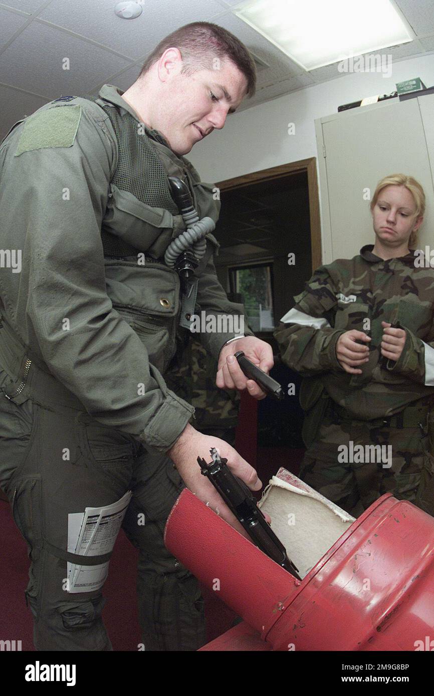 US Air Force Captain John Kelly, 22nd Fighter Squadron, receives a 9mm ...