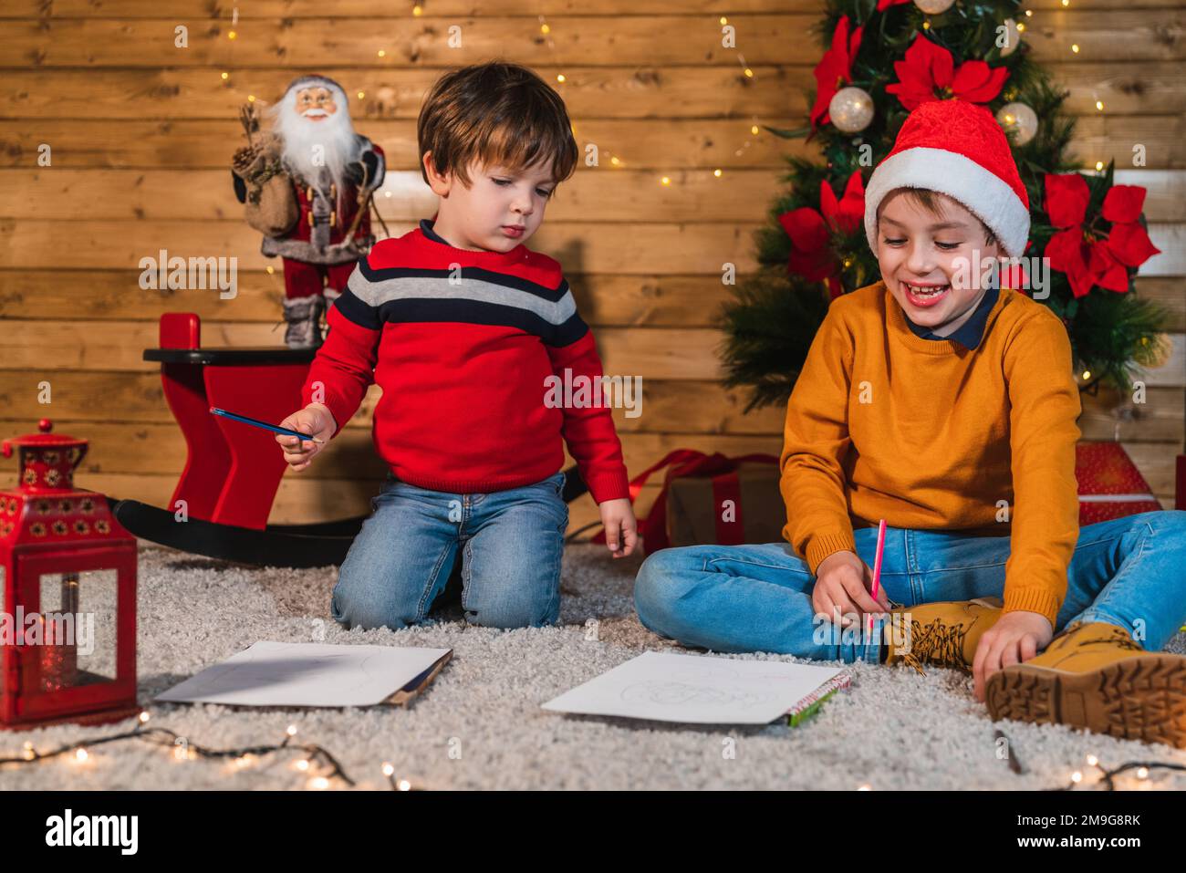 Caucasian children writing the letter to the three kings at christmas ...