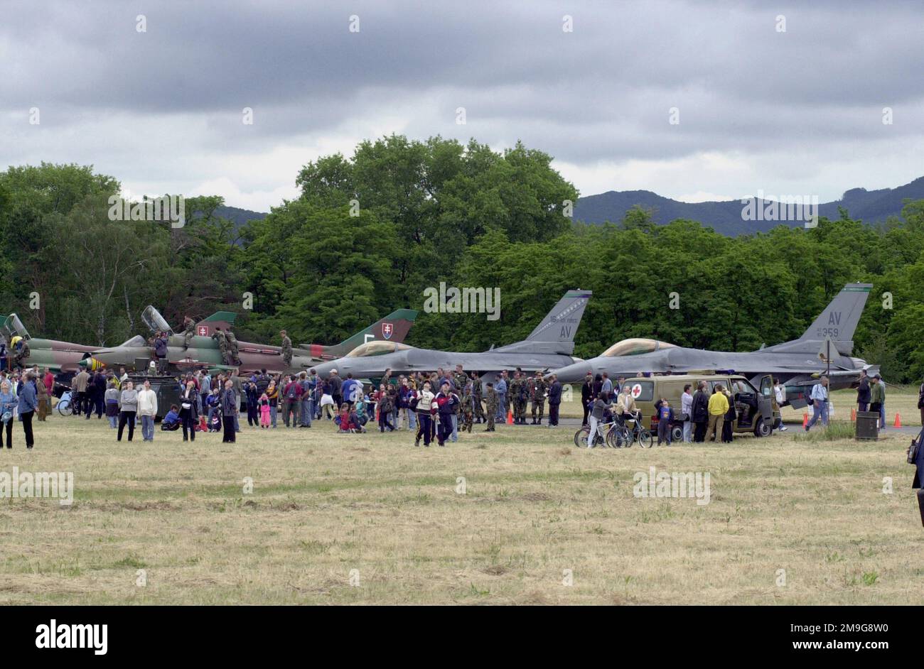 A crowd looks at two F-16 Fighting Falcon aircraft from the 555th ...