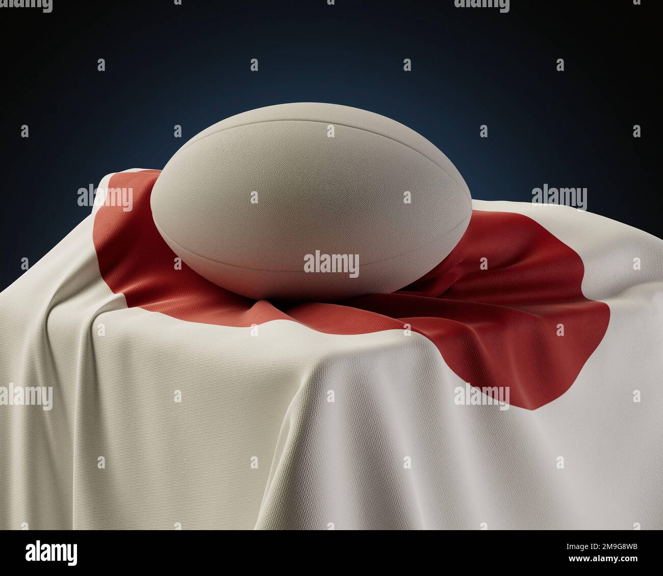 A regular rugby ball resting on a Japan flag draped over a plinth on an ...