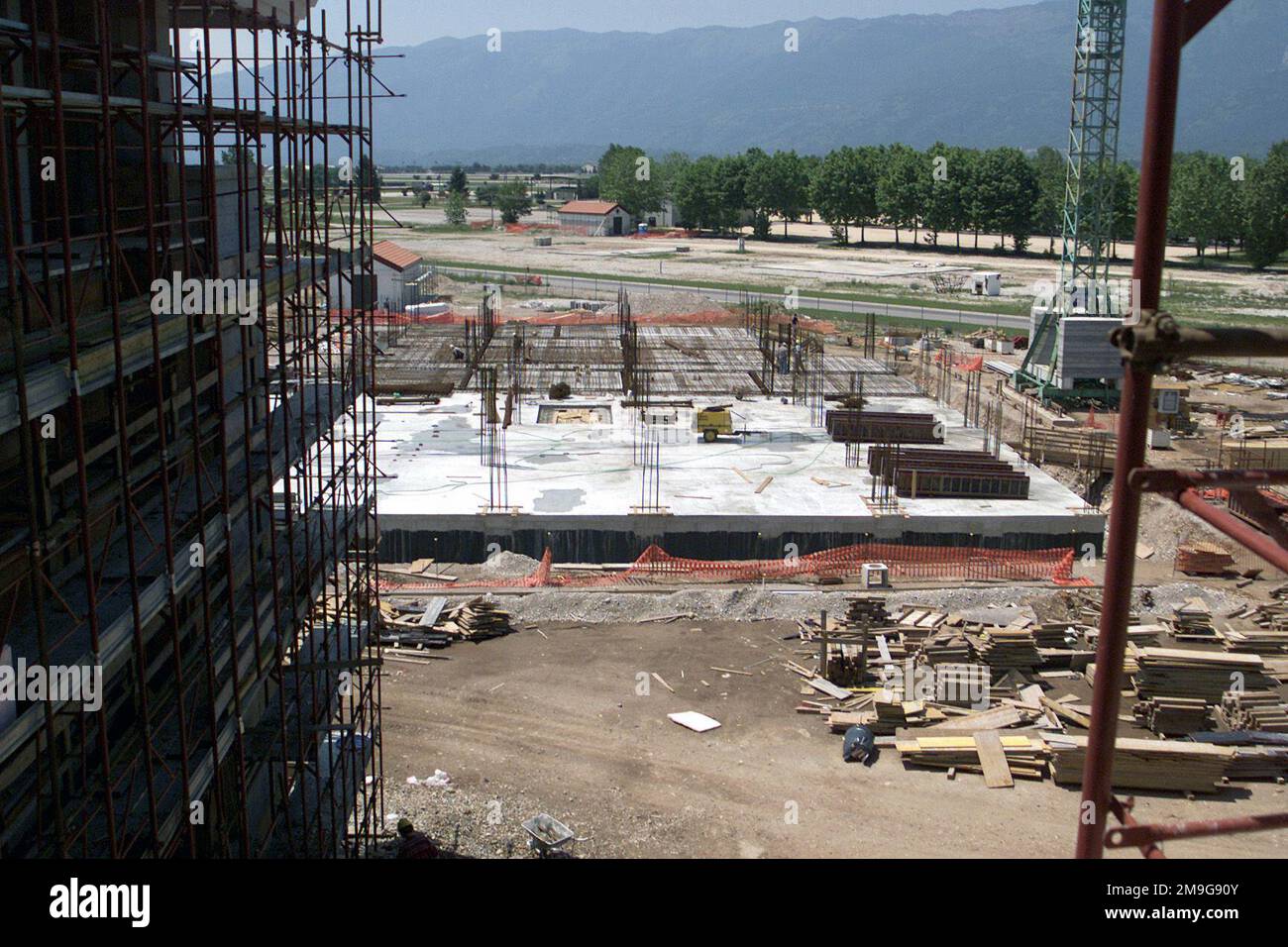 Italian construction workers continue work on the new dorms at Aviano ...