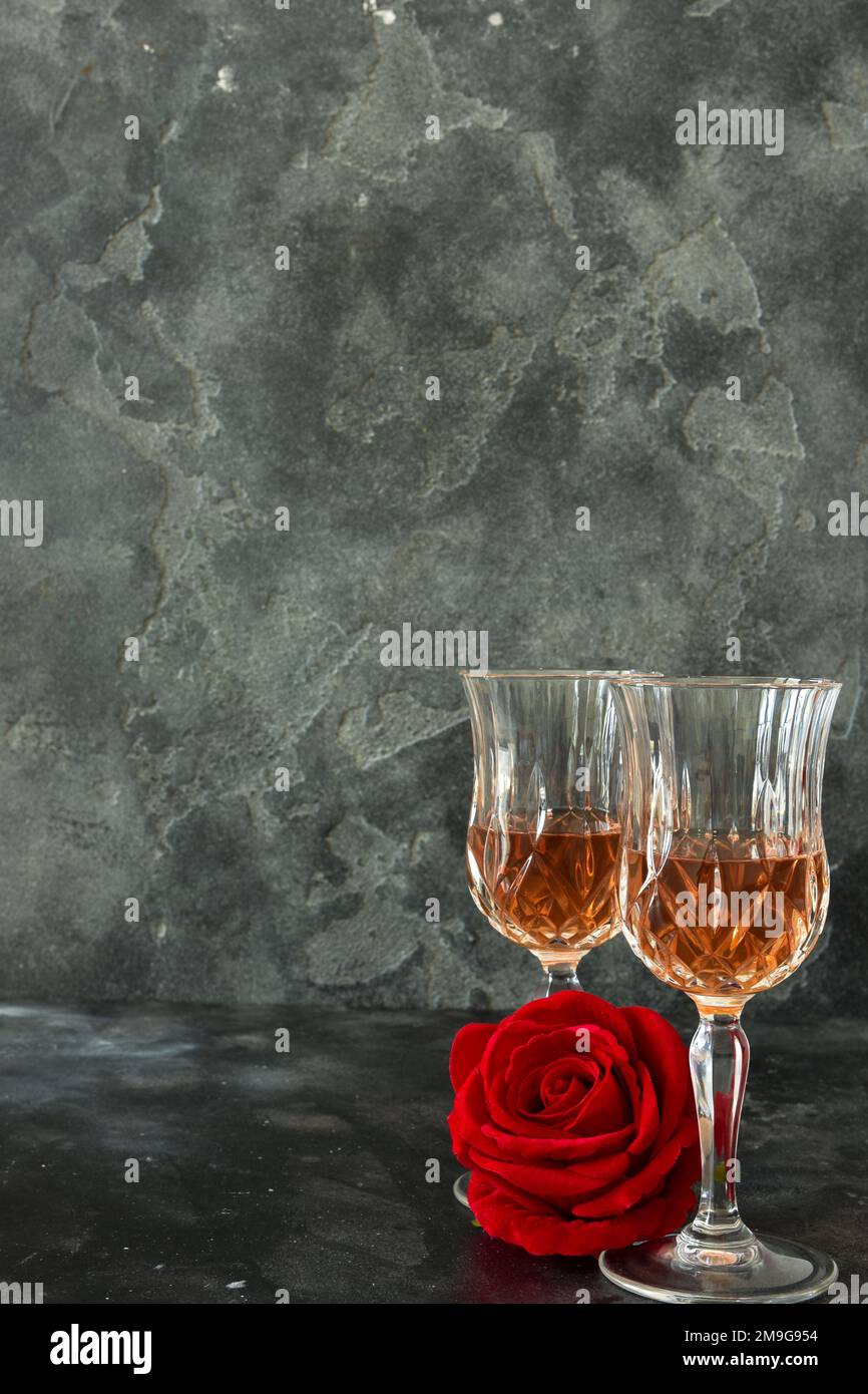 Close up two glasses of liquor and a rose on a black background Stock ...
