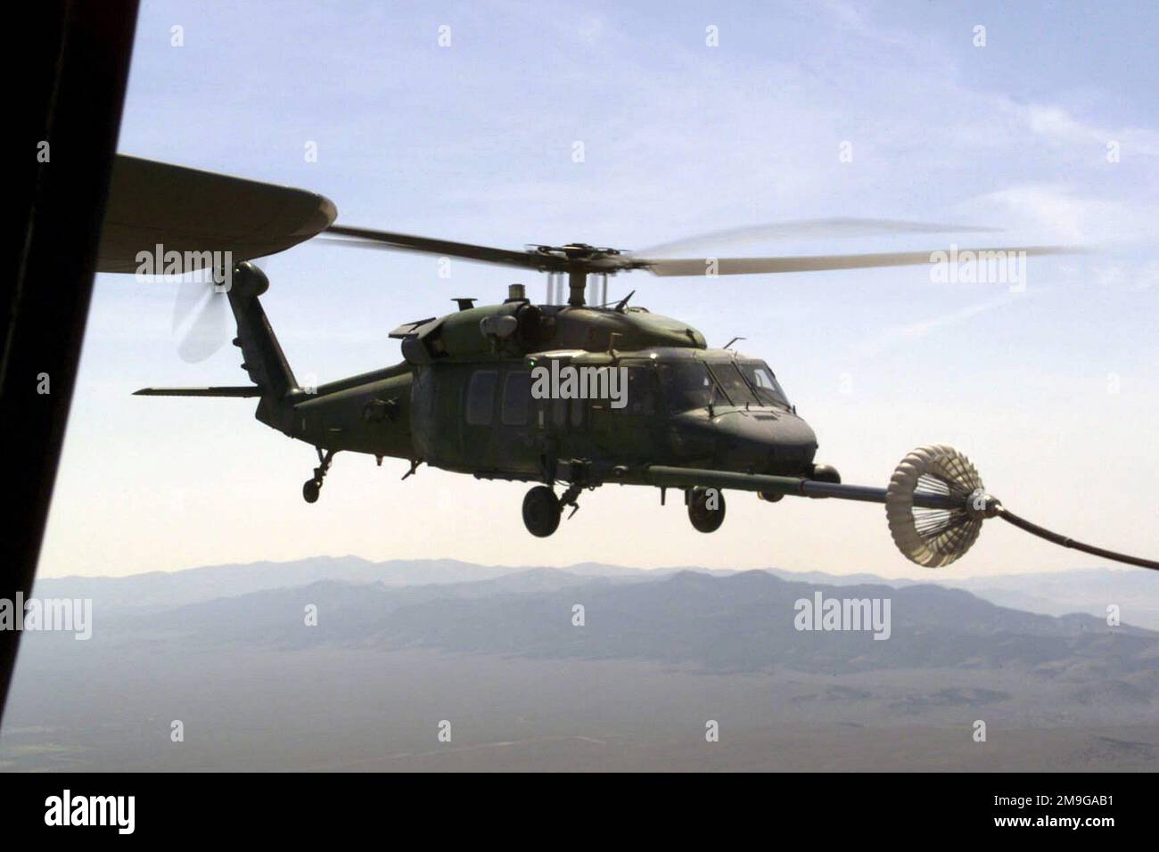 An HH-60 helicopter from the 41st Rescue Squadron re-fuels from an HC ...