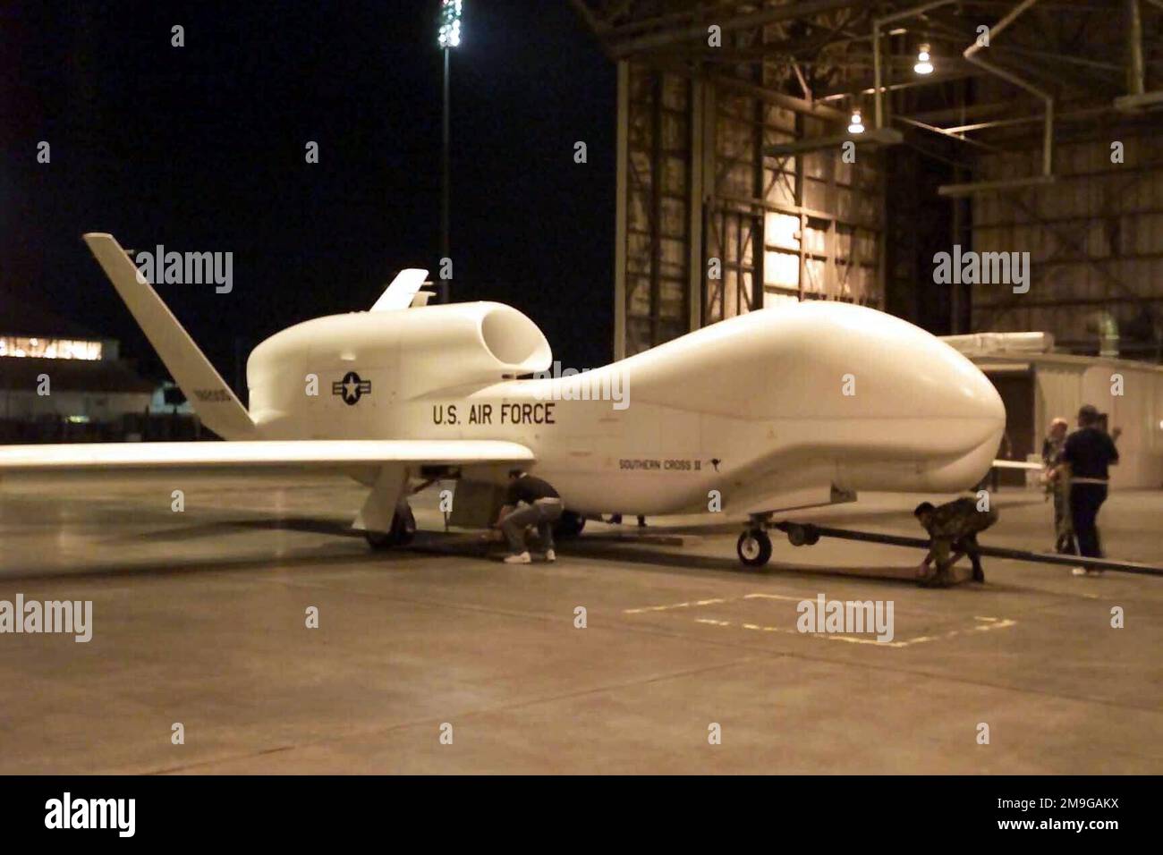 Recovery crews tow the Global Hawk unmanned aircraft after its arrival ...
