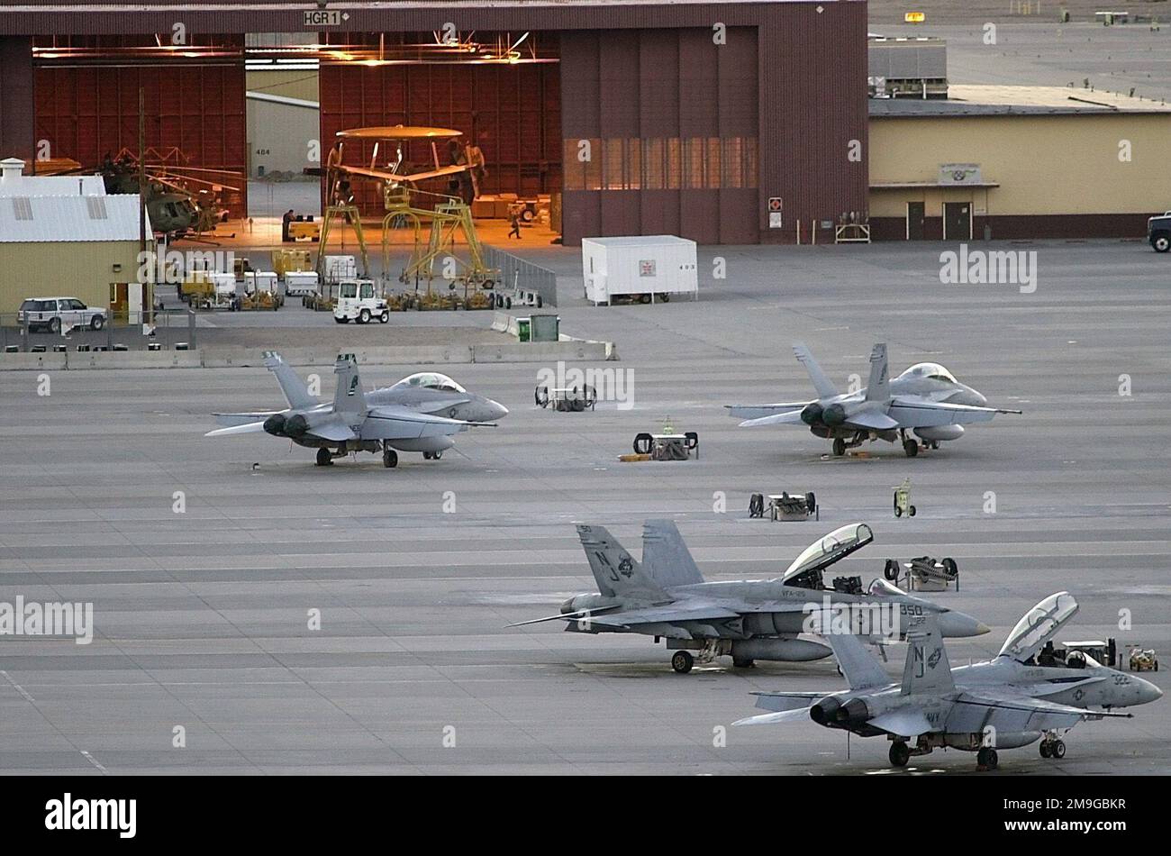 Navy and Marine F-18D Hornets are stationary on a flightline after ...