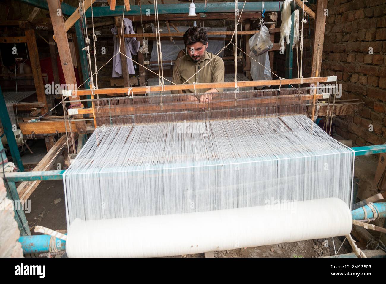 Weaver producing woolen shawls on a handloom, Islampur, Swat Valley ...