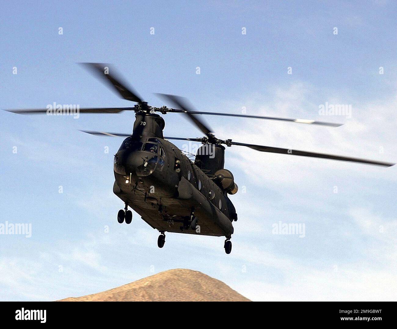 An Army CH-47 Chanook helicopter moves in to pick up detainees during a ...