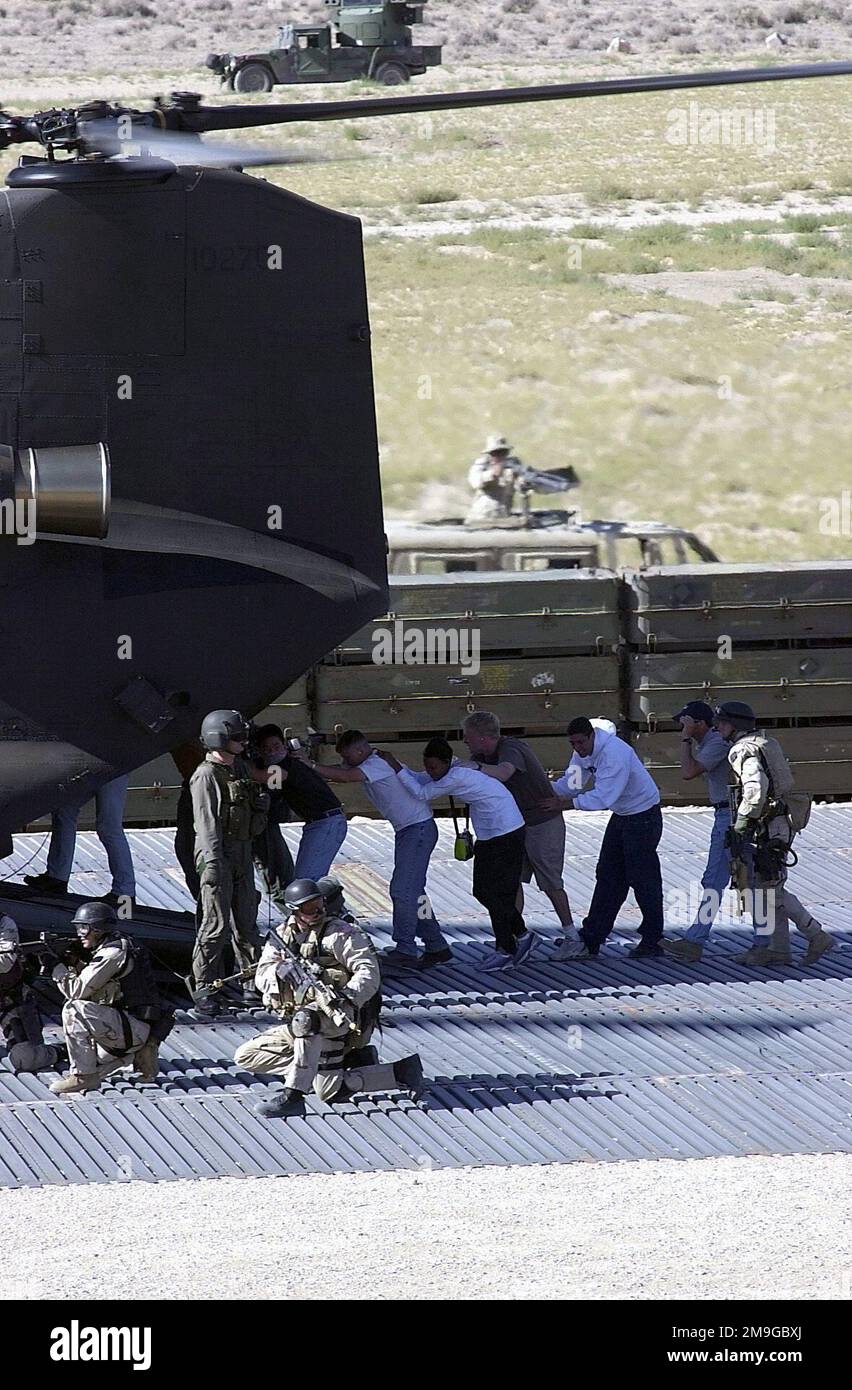 An Army CH-47 Chanook helicopter picks up detainees during a simulated ...