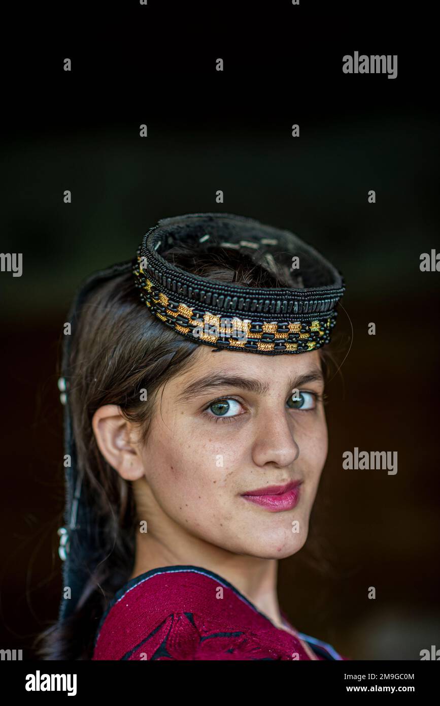Portrait of a Kalash beautiful girl with traditional beaded headdress ...