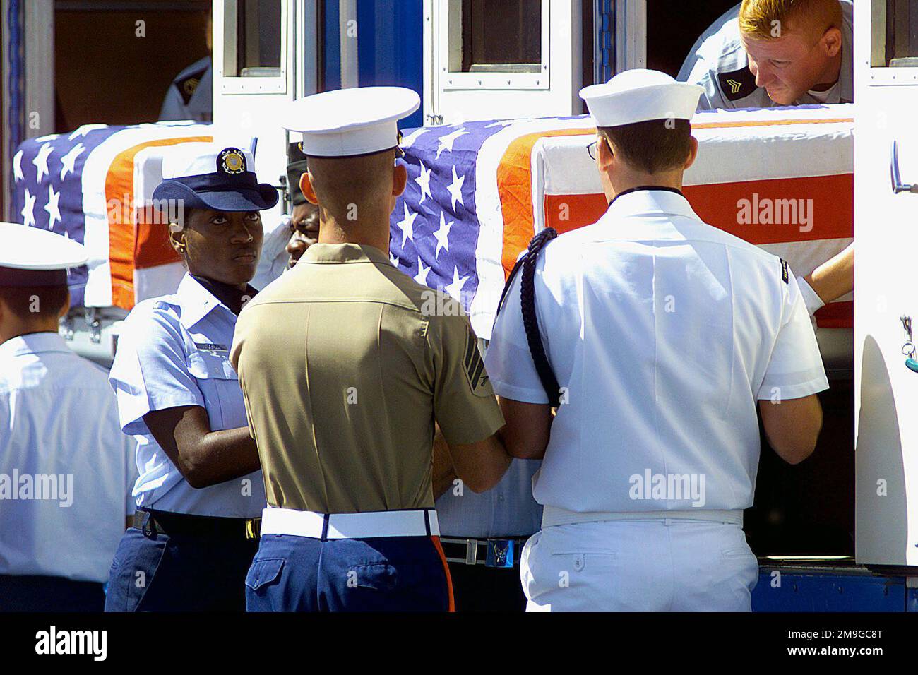 All service honor guard members lift transfer cases carrying the ...