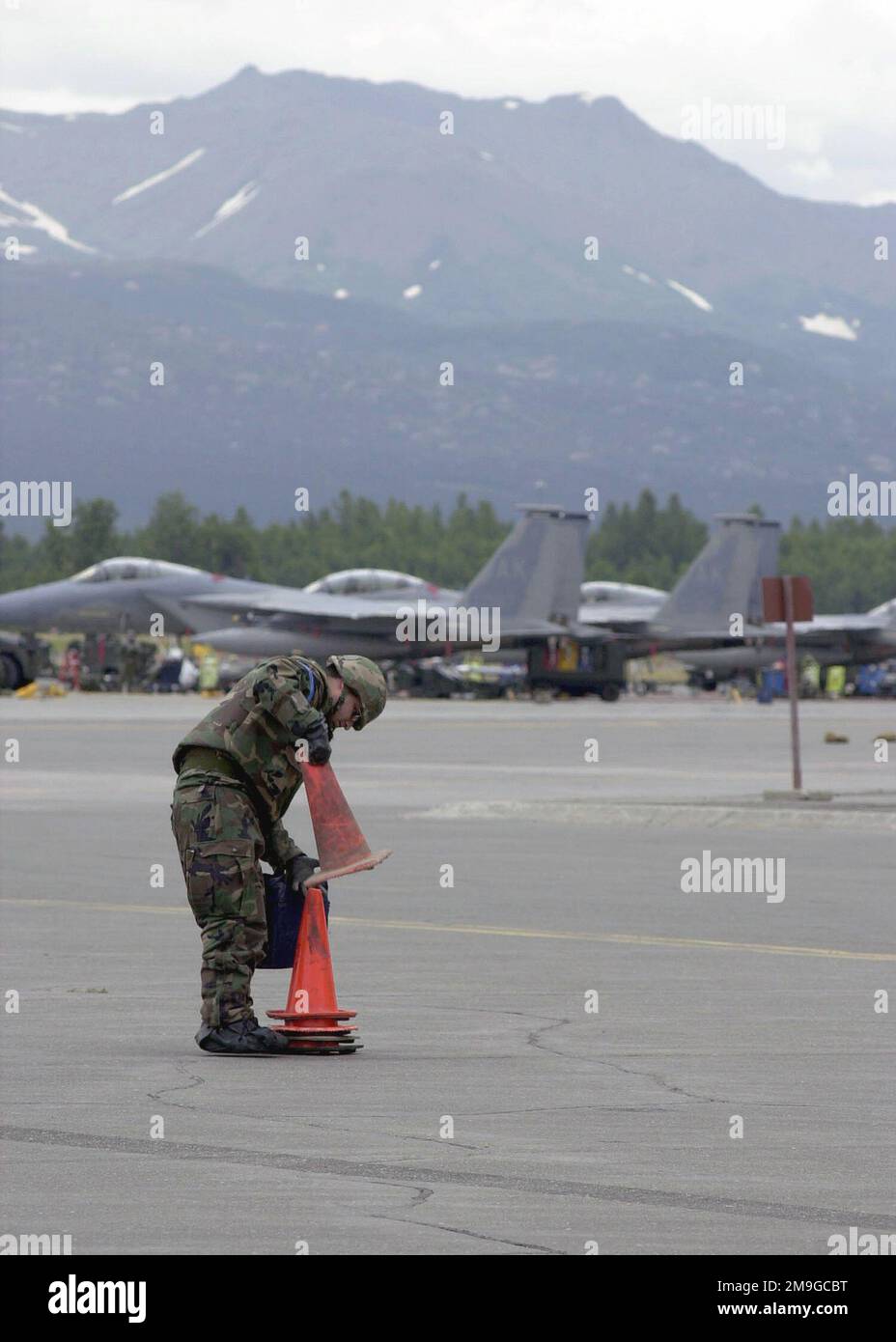 A 3rd Operations Support Squadron troop places cones to mark off a UXO ...
