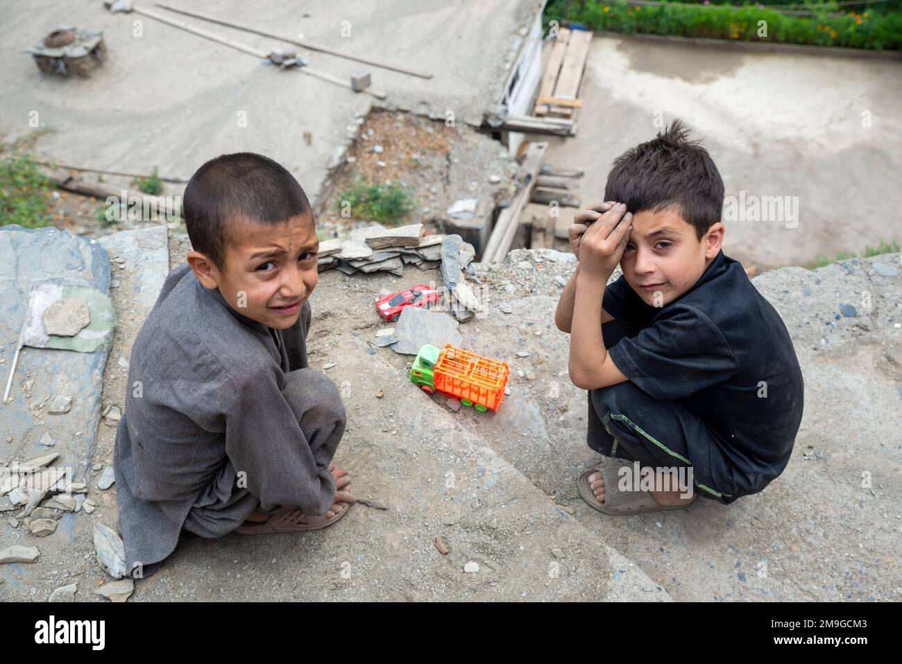 Two Kalash kids playing with a toy truck, Bumburet Valley, Pakistan ...