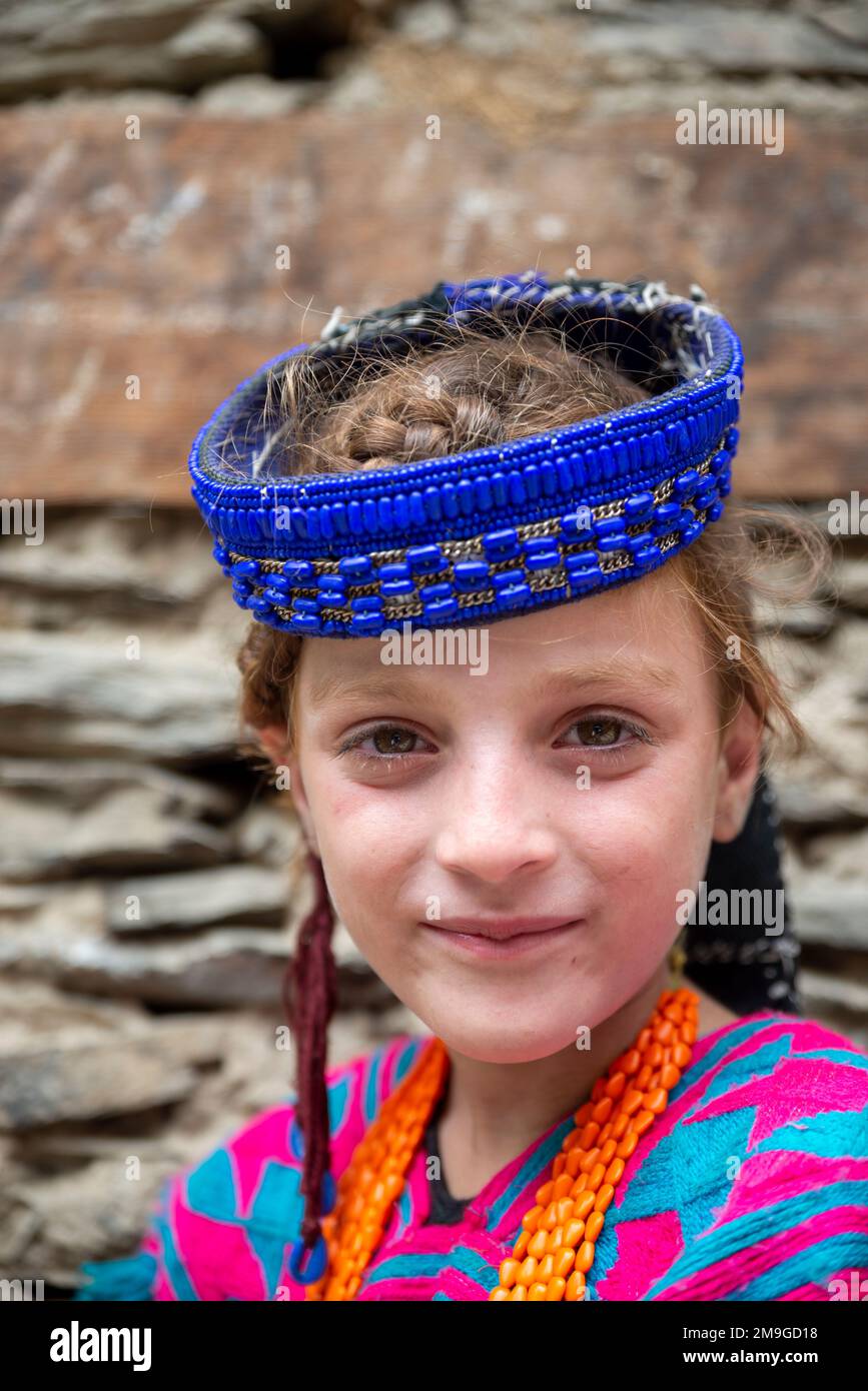 Close-up portrait of a young Kalash girl wearing traditional clothes ...