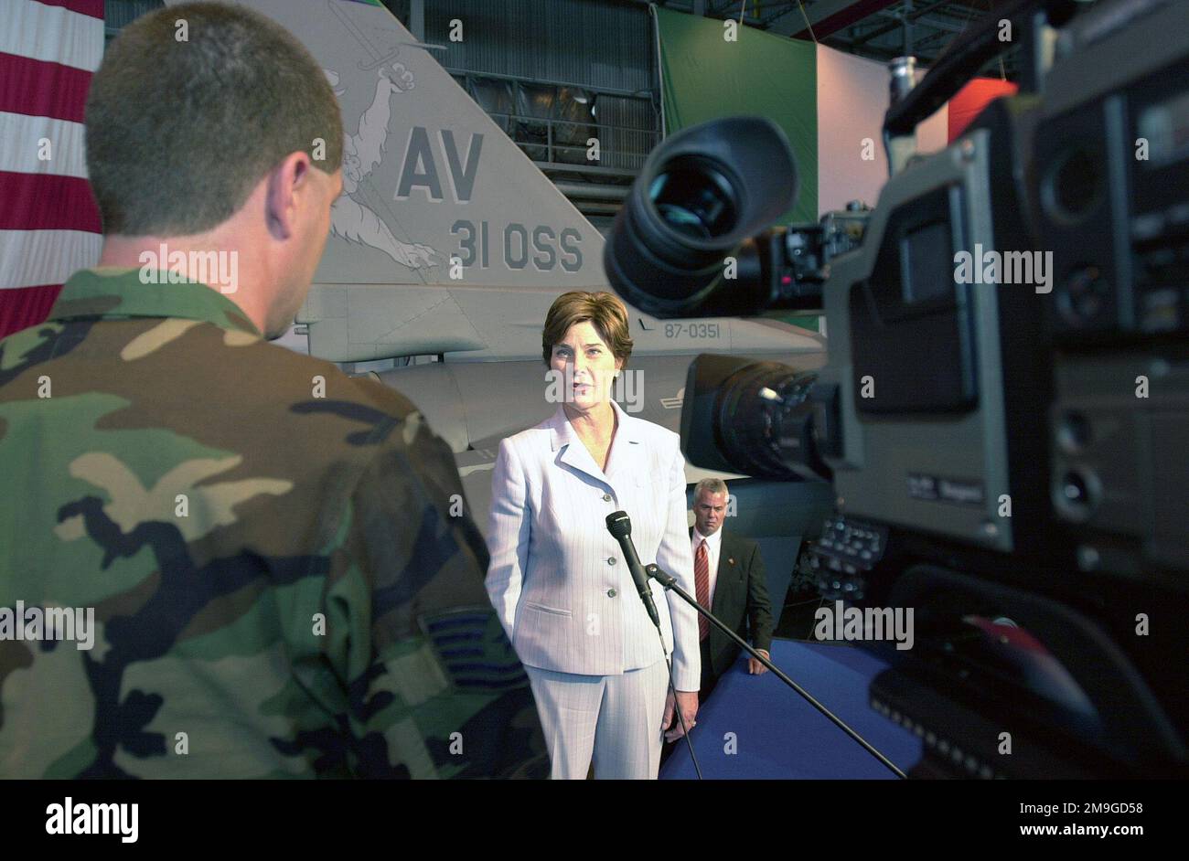 First Lady, Mrs. Laura Bush, with an F-15 Eagle as a background, is ...