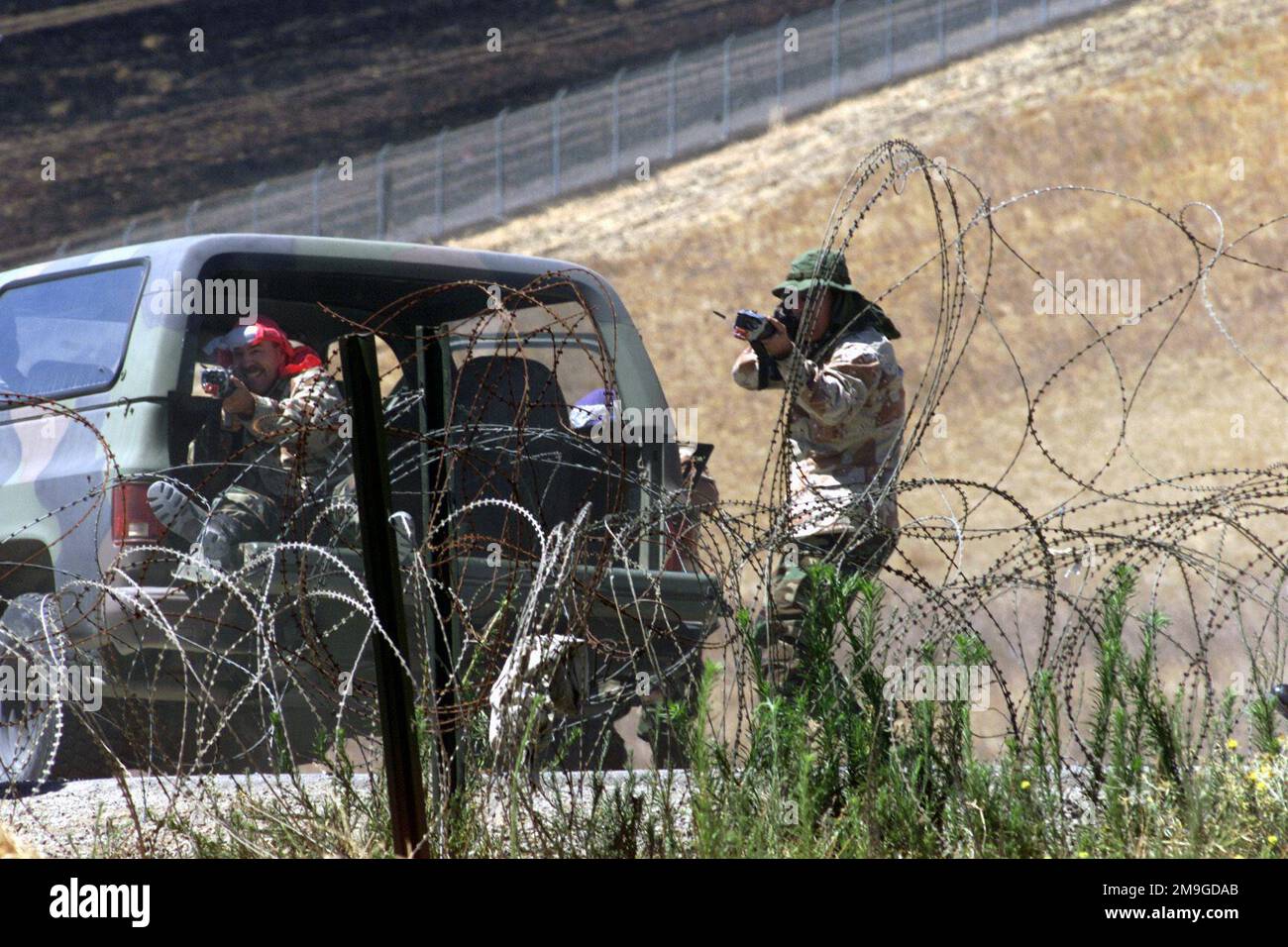 Oppostion Forces storm the entry control point in a military vehicle ...