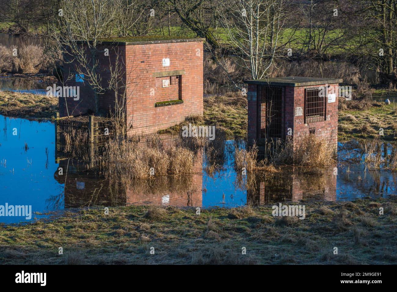 Two brick buildings with their reflections in Wyver Lane Pool, a ...