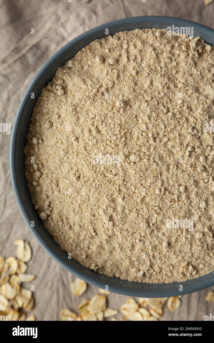 Organic White Oat Flour in a Bowl on a gray background, top view. Flat ...