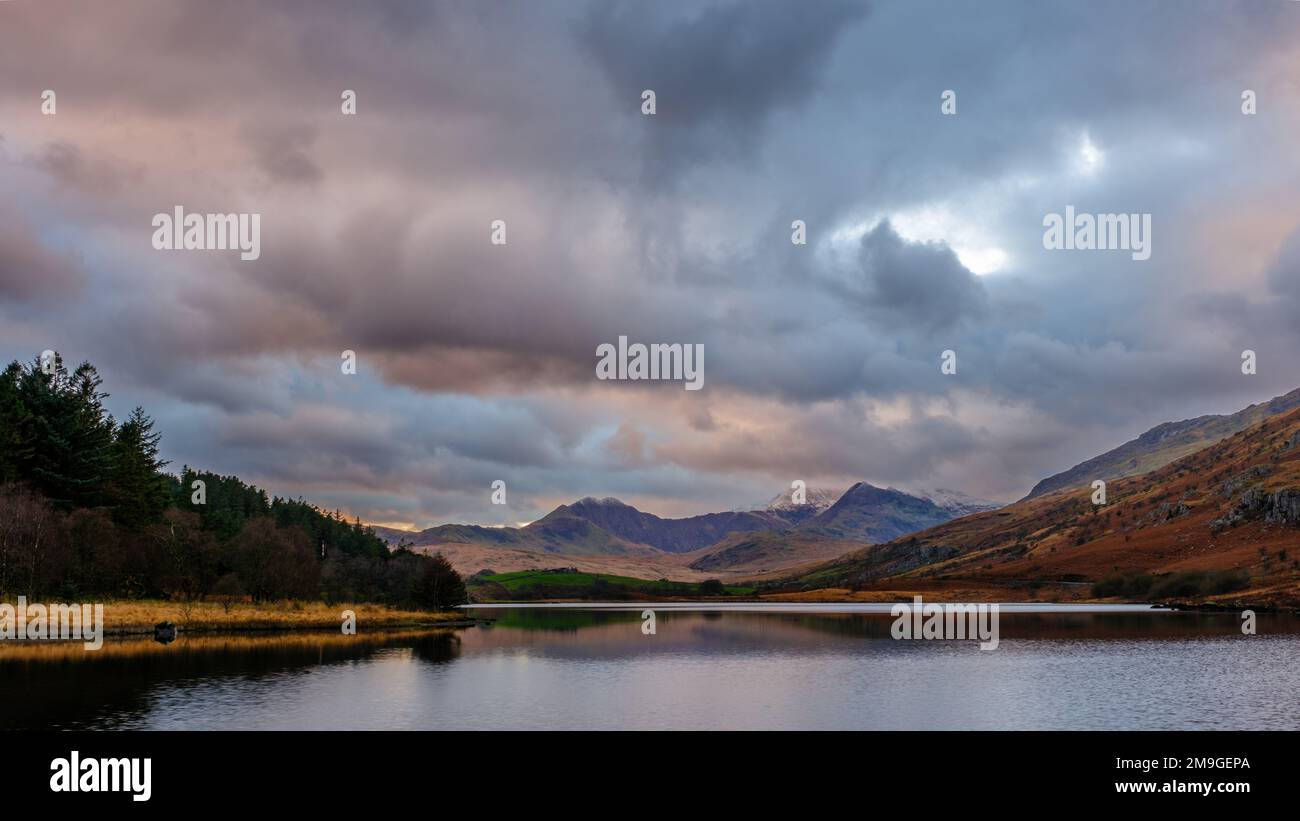 Perfect reflection of snow covered Snowdon Horseshoe mountains in a lake in Snowdonia National ...