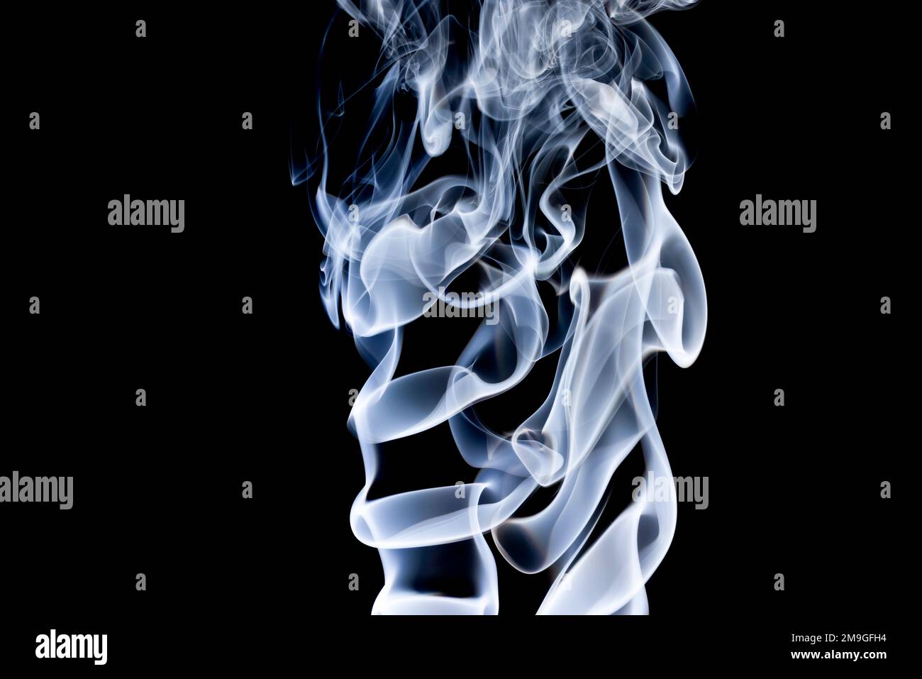 Artistic looking smoke swirls photographed against a plain black ...