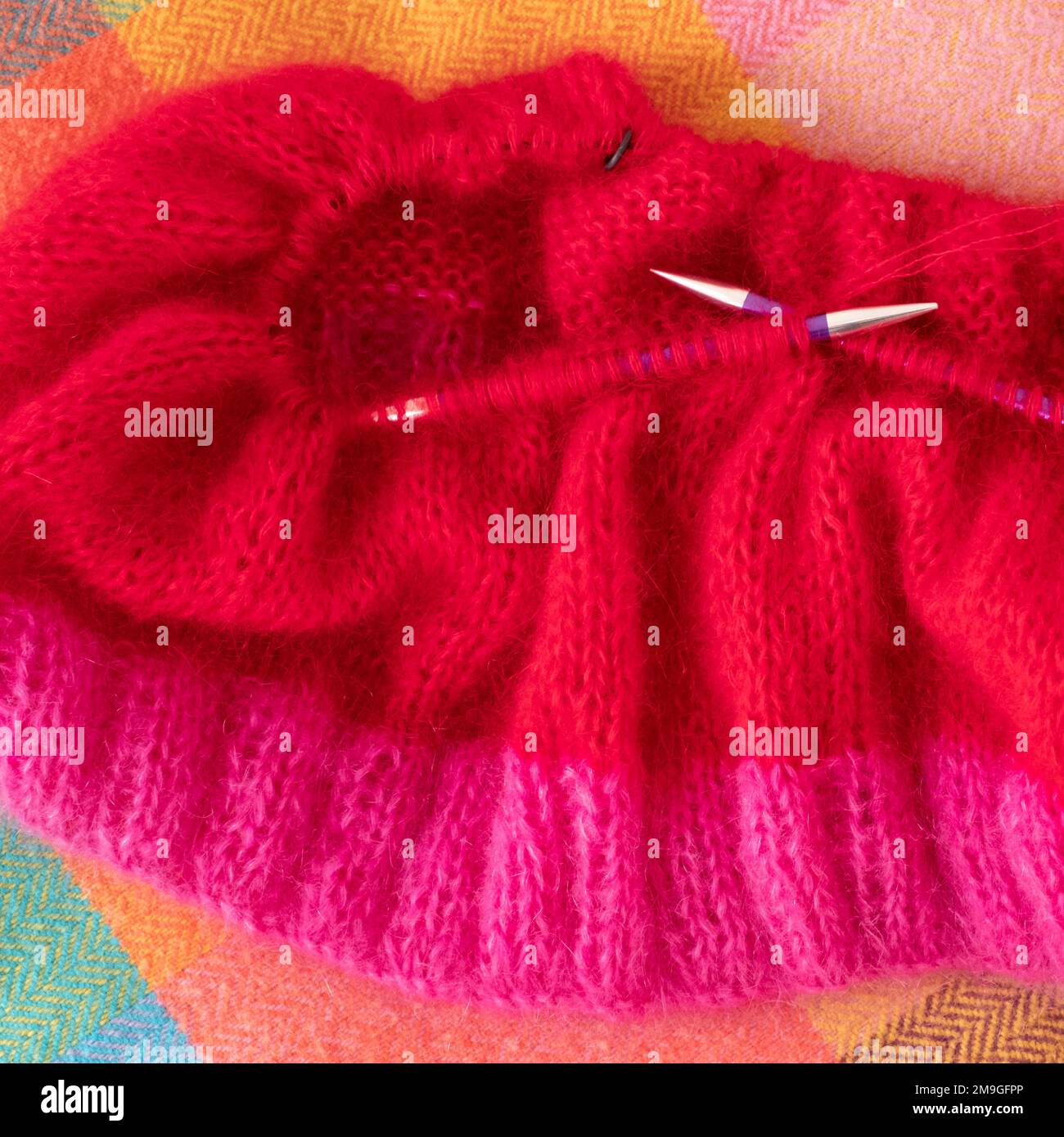 Bright pink and red mohair yarn hand knitted sweater with stitches ...