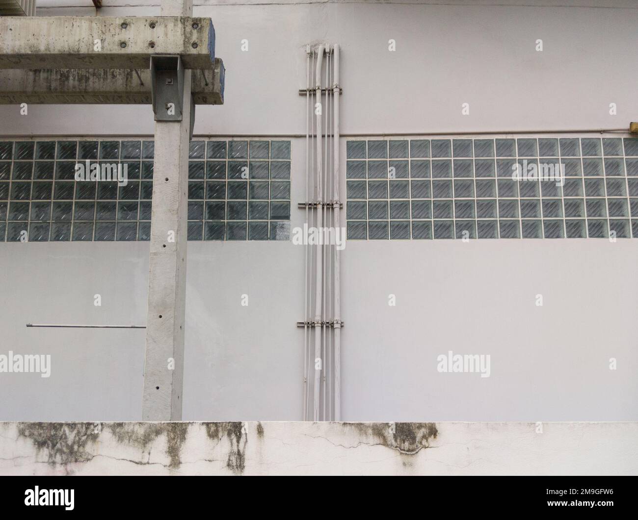 The white pipe rows along the concrete wall to drain the water of the ...