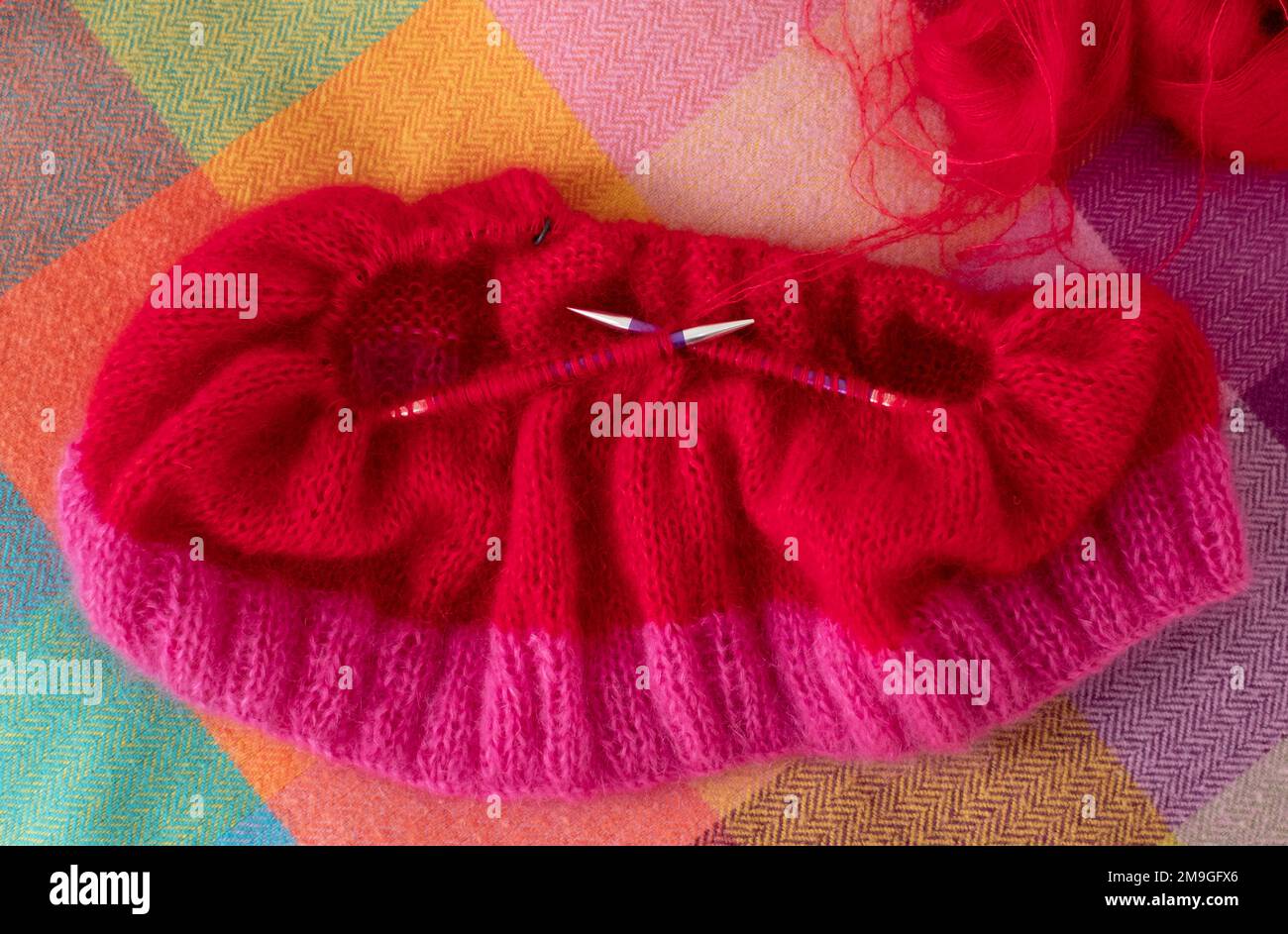 Bright pink and red mohair yarn hand knitted sweater with stitches ...