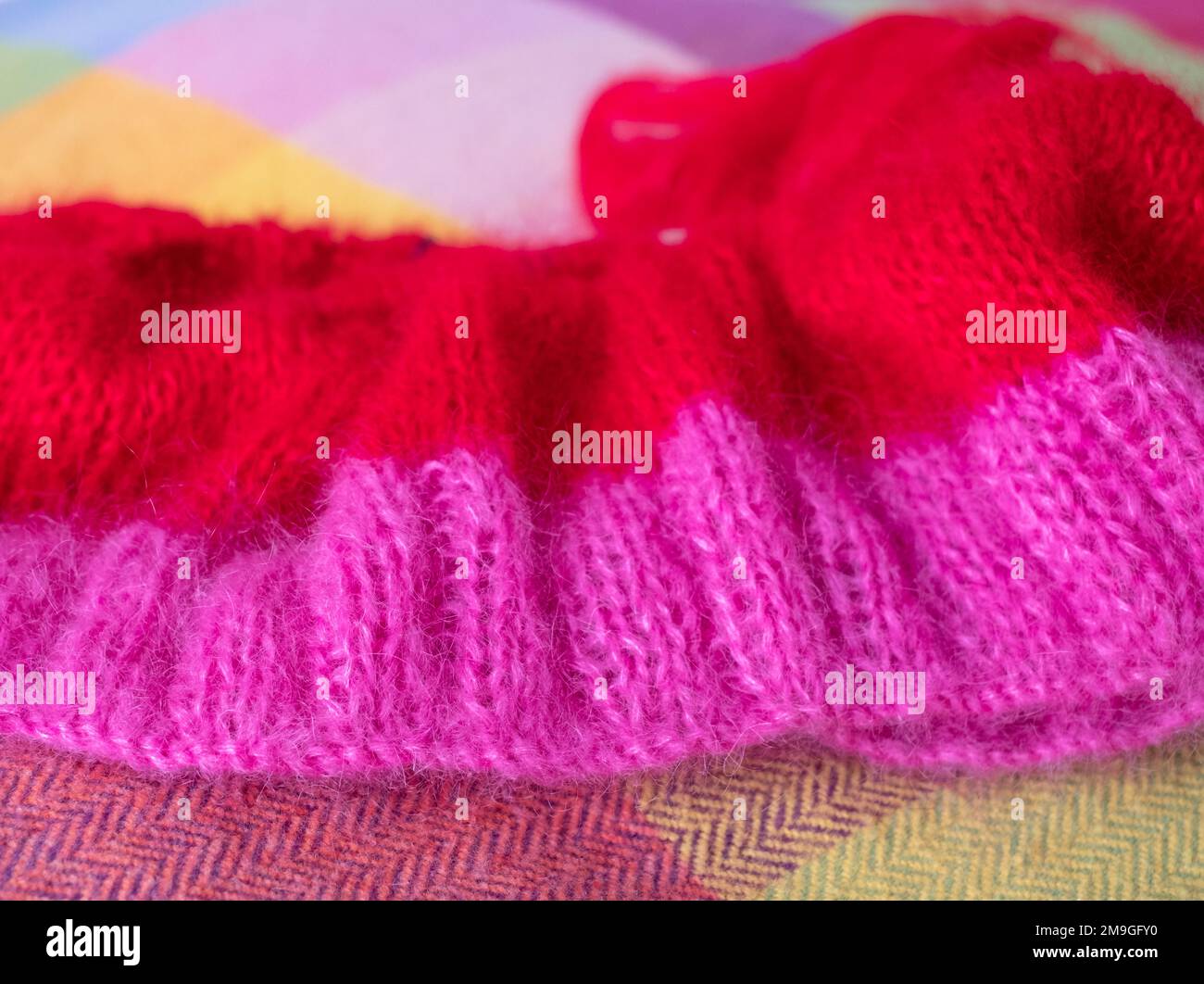 Bright pink and red mohair yarn hand knitted sweater with stitches ...