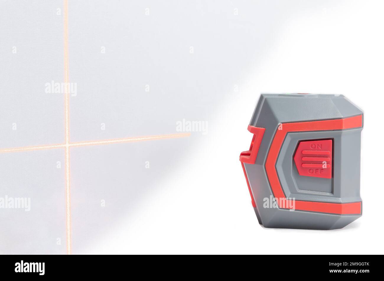 Self leveling cross hair laser on white background Stock Photo - Alamy