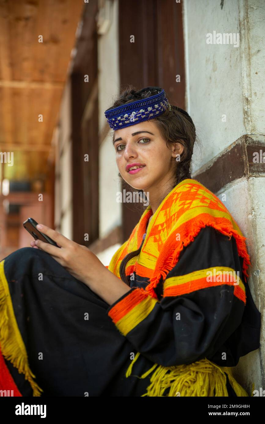 Portrait of a Kalash girl with a smarphone and colorful traditional ...