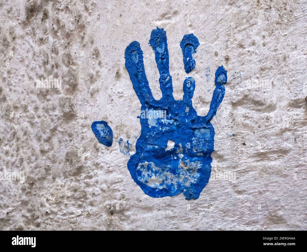 Blue Colorful Hand print on white wall detail Stock Photo - Alamy