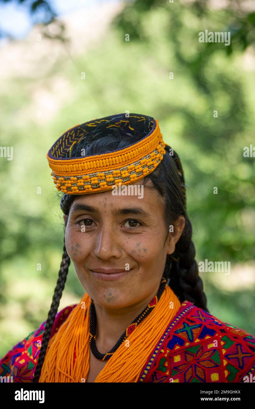 Portrait of an adult Kalash woman with traditional colorful beaded ...
