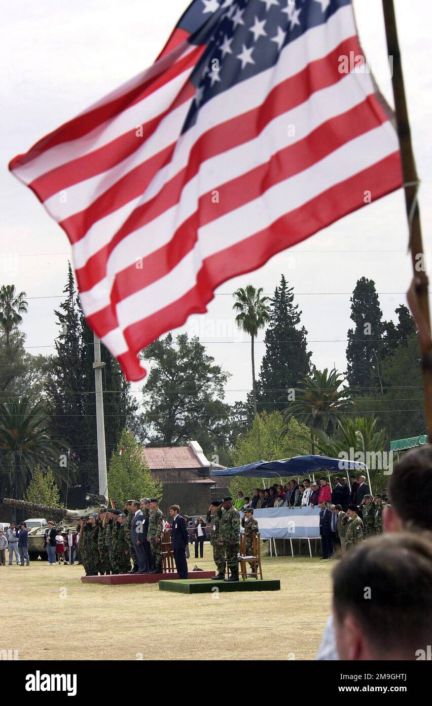 Military and civilian leaders stand during the playing of the national ...