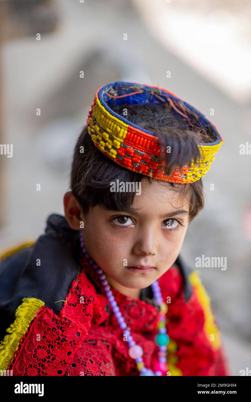 Portrait of a young Kalash girl with traditional beaded headdress ...