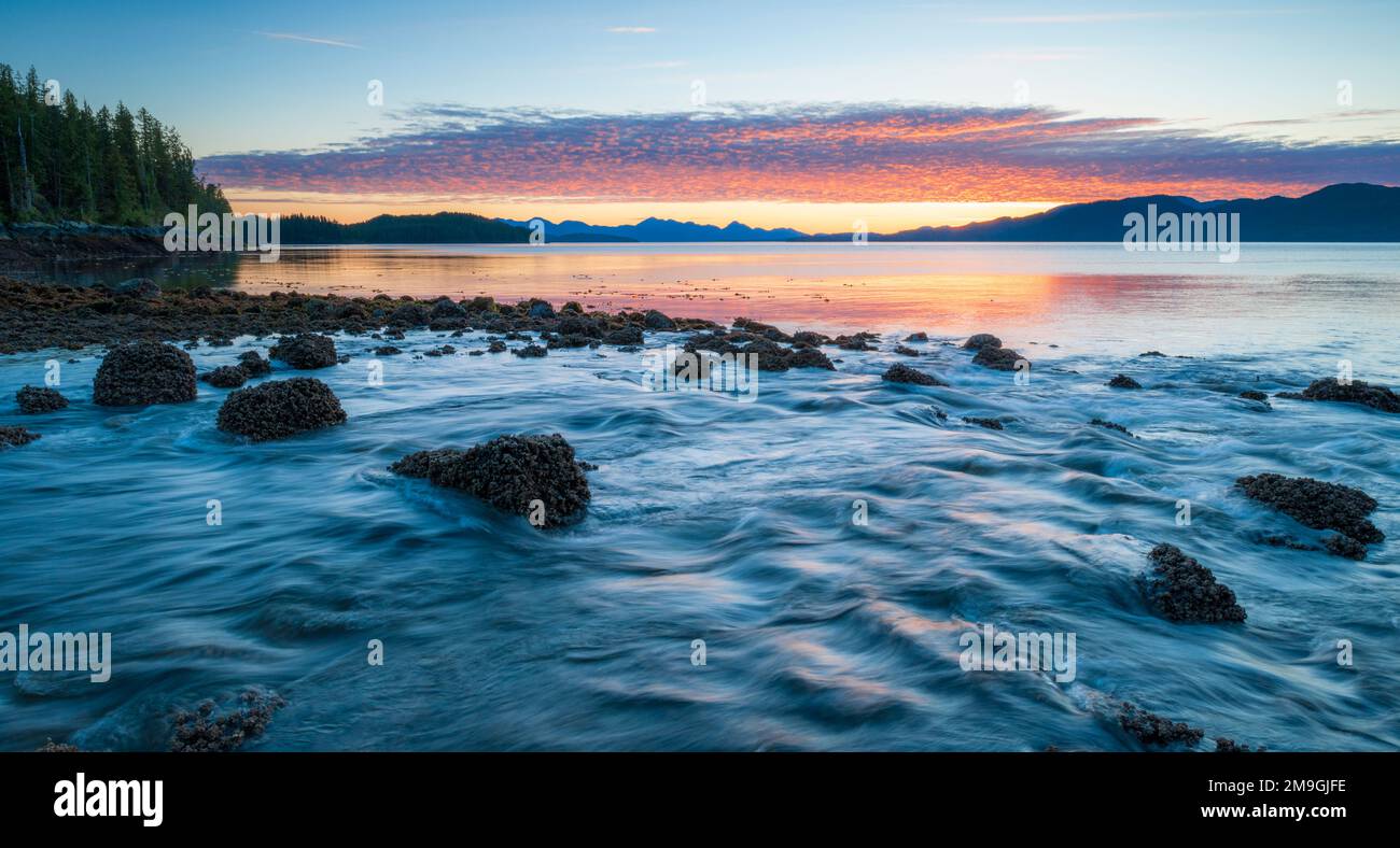 Landscape with coastline under moody sky at sunset, British Columbia ...