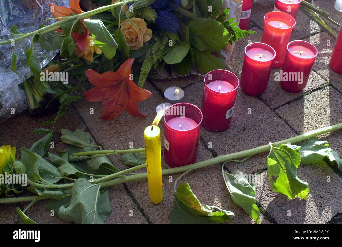 At the base of the Ramstein Air Bases West Gate, candles flicker in the ...