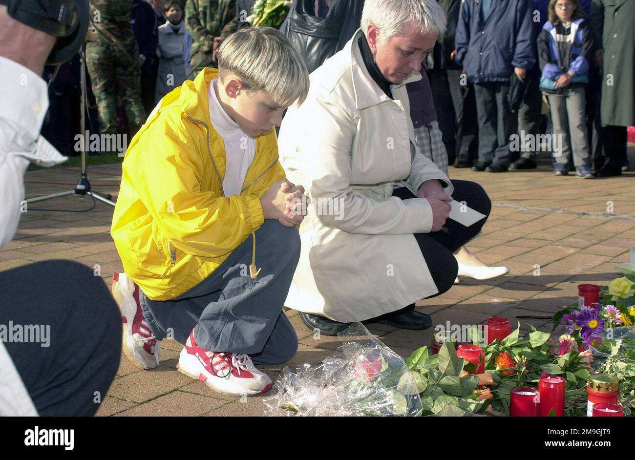 Wreaths, flowers, and candles are placed at the base of the Ramstein ...