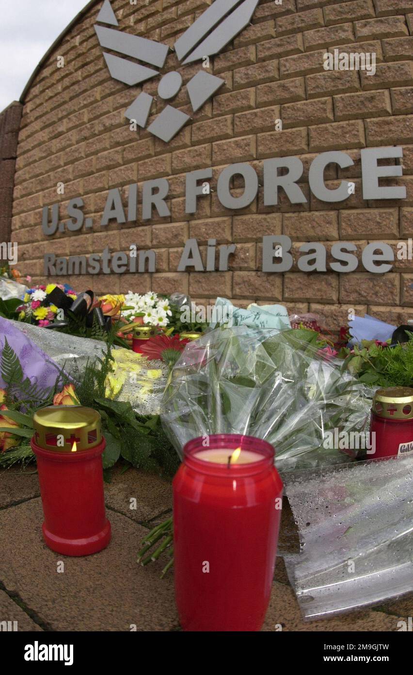 At the West Gate candles flicker in the wind next to wreaths and ...