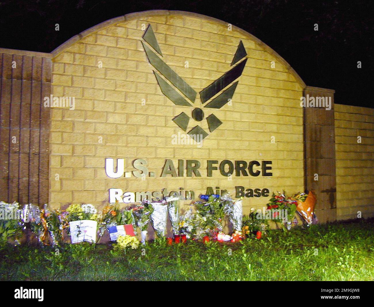 The Ramstein Air Base, East Gate at night. Flowers and candles are ...