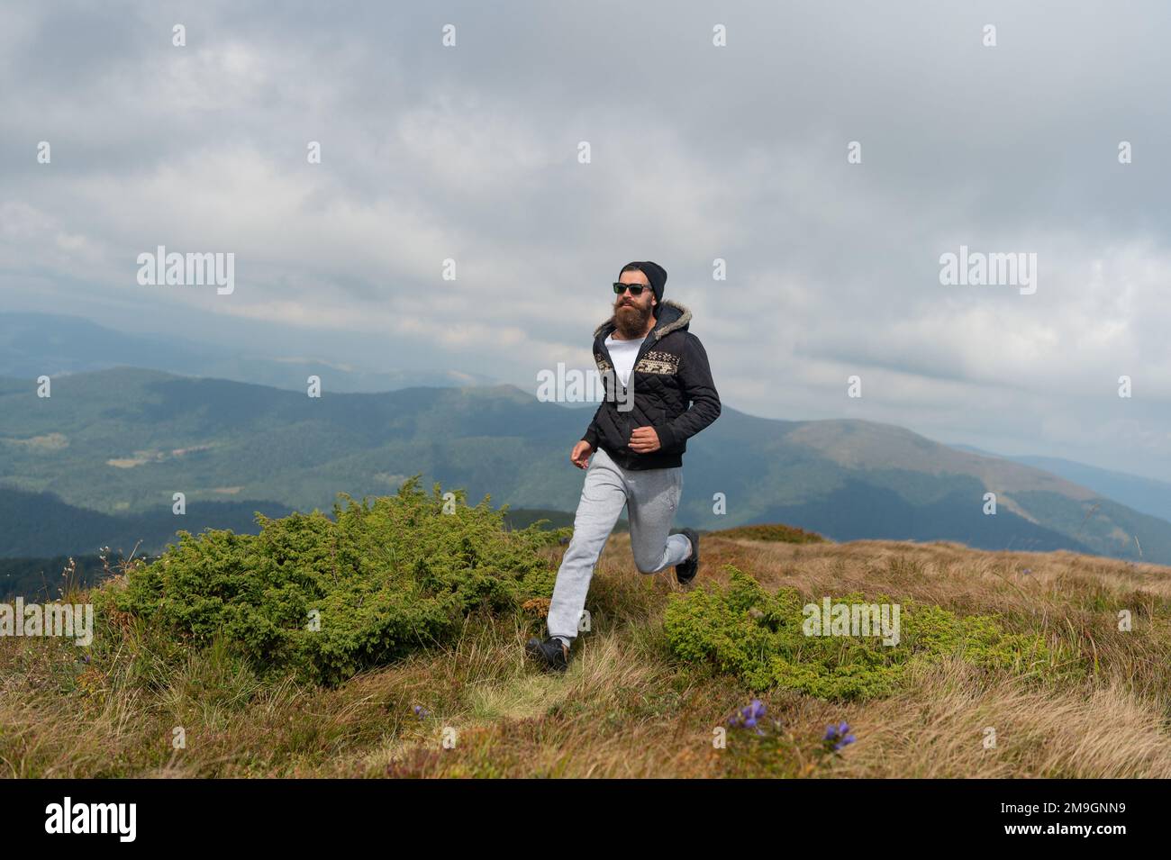 full length of runner man running outside. runner man running on fresh ...