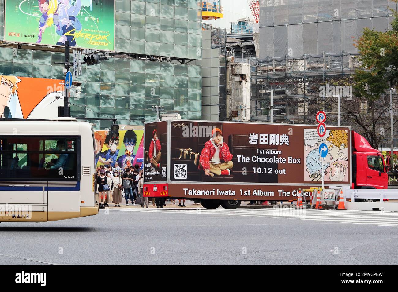 TOKYO, JAPAN - October 11, 2022: An advertising truck and a bus going ...