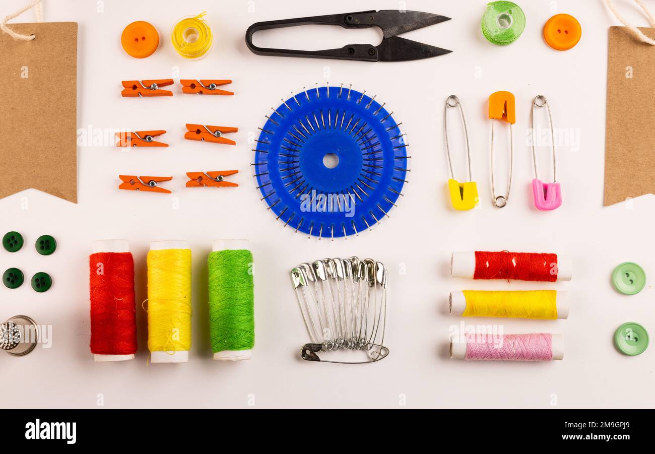 Image of sewing materials with scissors, buttons and threads on cream ...