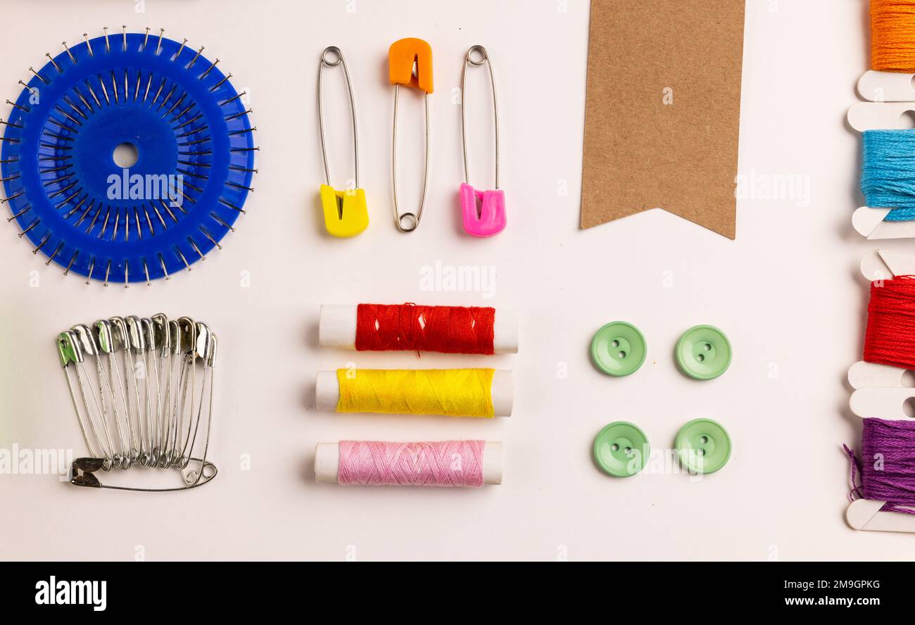 Image of sewing materials with scissors, buttons and threads on cream ...