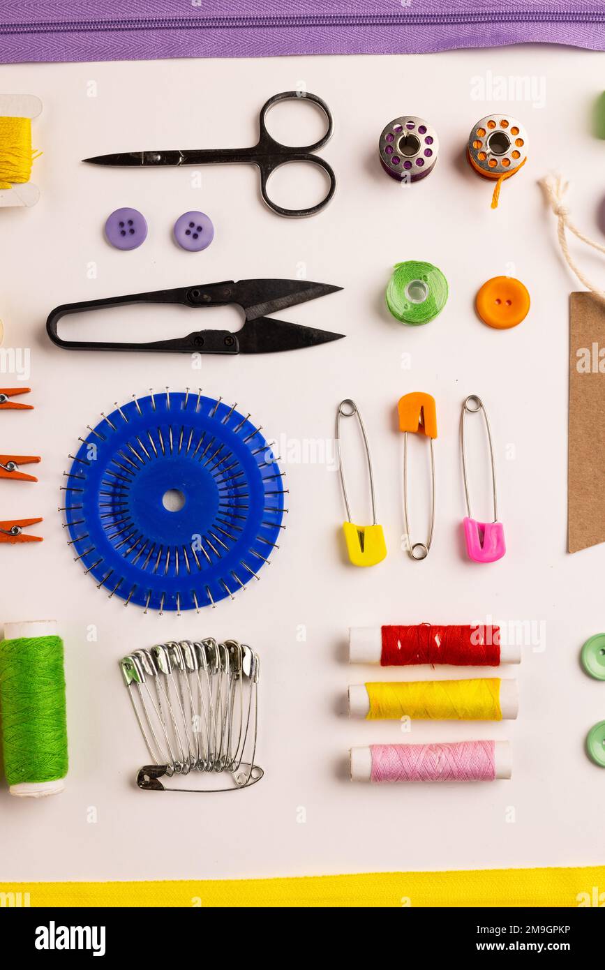 Image of sewing materials with scissors, buttons and threads on cream ...