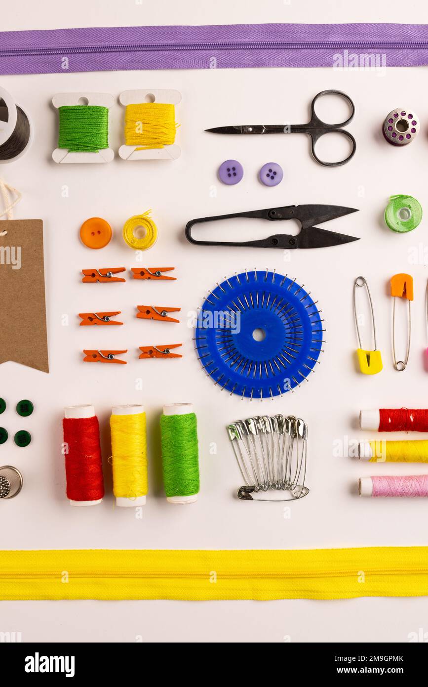 Image of sewing materials with scissors, buttons and threads on cream ...