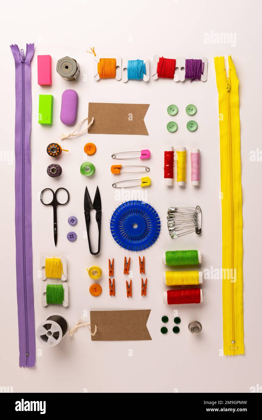 Image of sewing materials with scissors, buttons and threads on cream ...