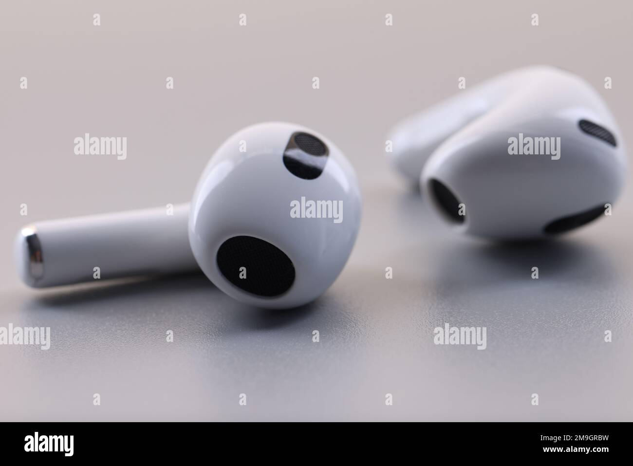 White headphones wireless headphones on gray background Stock Photo - Alamy