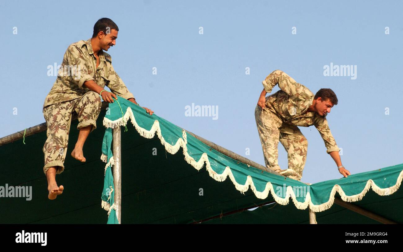 011014-F-7203T-005. [Complete] Scene Caption: Egyptian soldiers dress ...