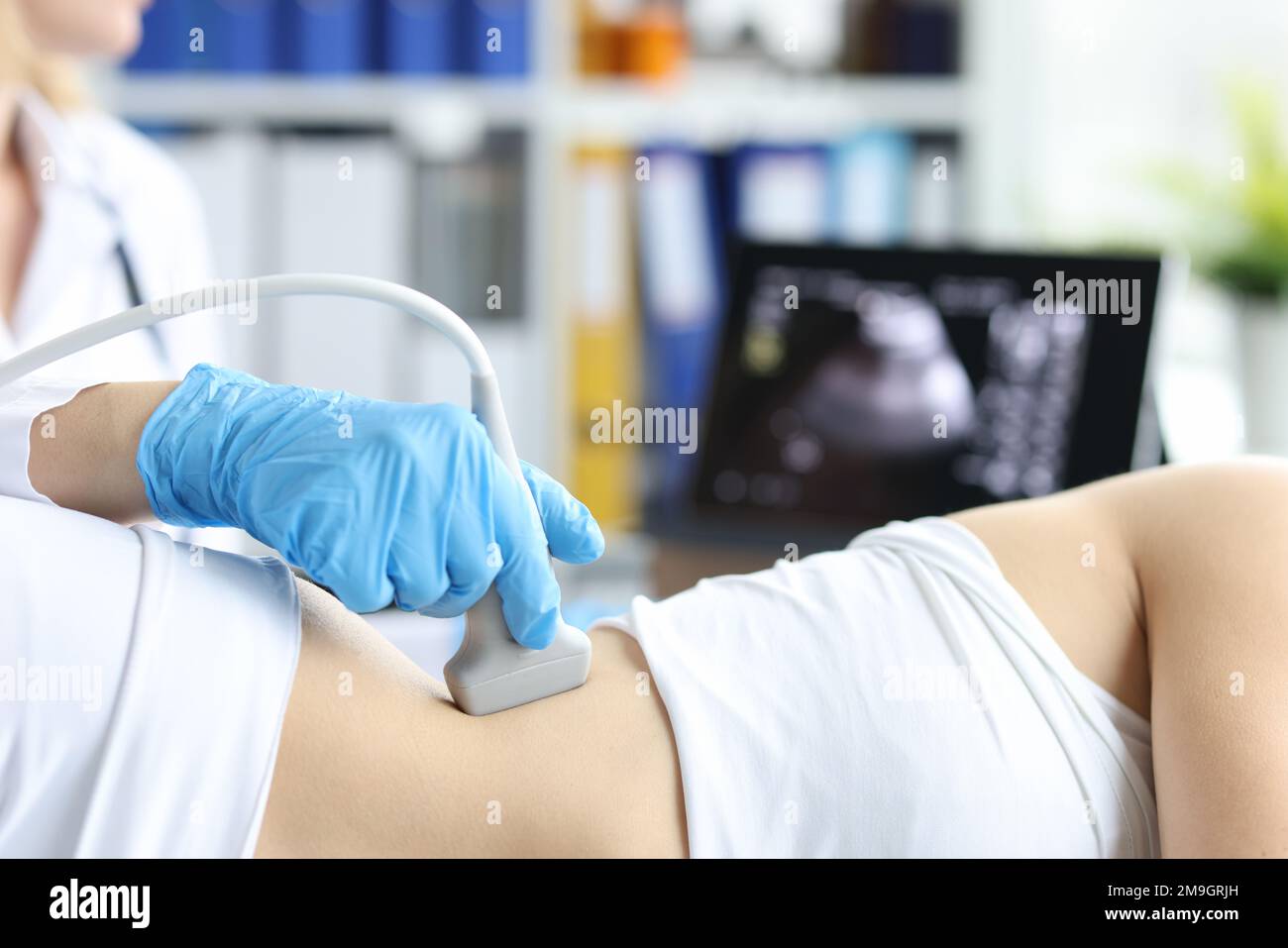 Doctor examines patient with prolapse of left kidney and spleen using ...